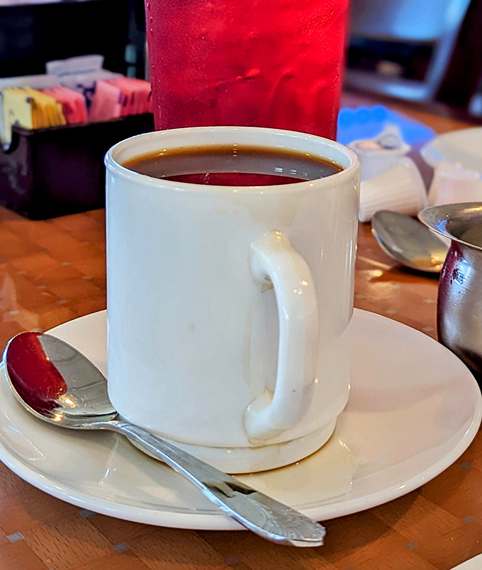 The humble white mug – delivering liquid motivation one refill at a time, no fancy latte art required.