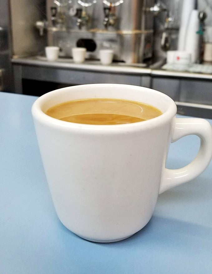 Coffee served in sturdy white mugs against the blue countertop&mdash;no fancy latte art needed when you're washing down the best ham sandwich in Michigan.