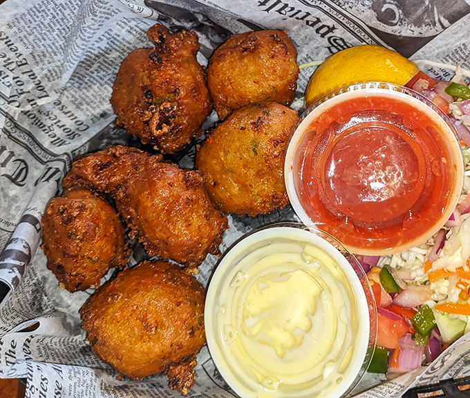 Golden-fried conch fritters that crunch like your favorite childhood memory, served with dipping sauces that make you wonder why you'd eat anything else.