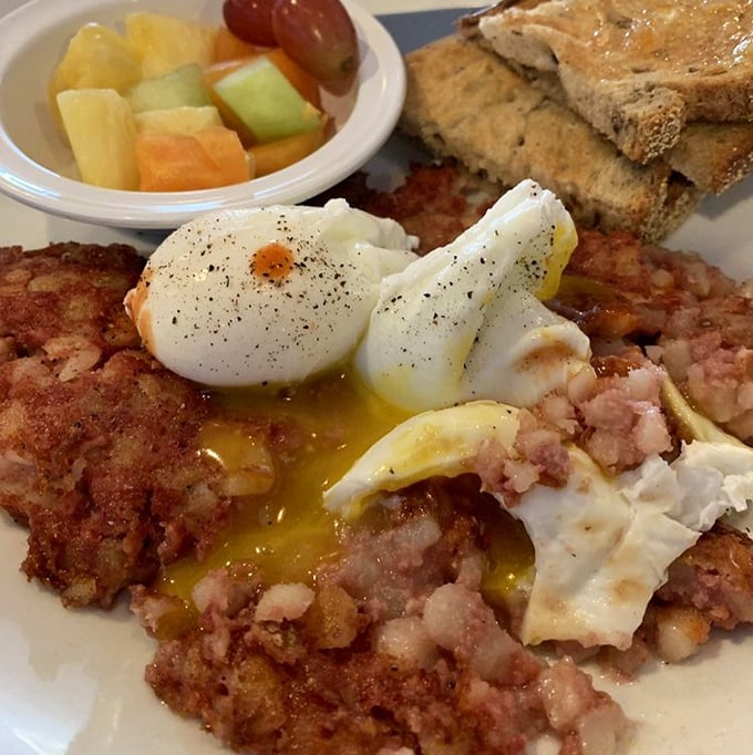 Corned beef hash topped with perfectly poached eggs—the breakfast equivalent of finding front-row concert tickets in your coat pocket. That runny yolk is nature's most perfect sauce.