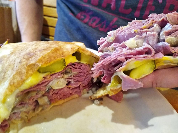 A sandwich so stuffed with corned beef it requires an engineering degree to eat. The pickle provides that perfect acidic counterpoint to the rich meat.