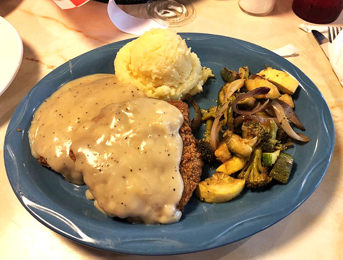 Country fried steak smothered in gravy that your cardiologist warned you about, but your taste buds are staging a rebellion.