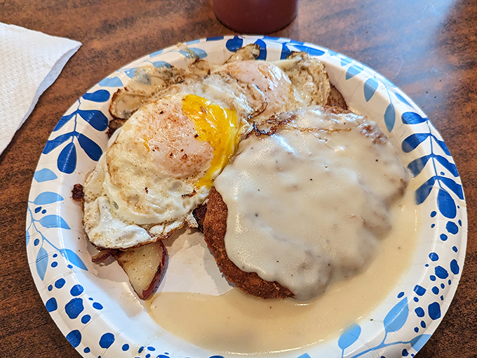 Country fried steak smothered in gravy with a sunny-side-up egg standing guard. This plate doesn't care about your diet &ndash; it cares about your happiness.