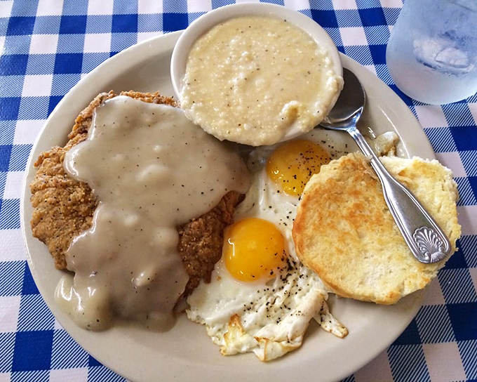Country fried steak swimming in peppery gravy alongside creamy grits&mdash;the kind of breakfast that makes alarm clocks forgivable.