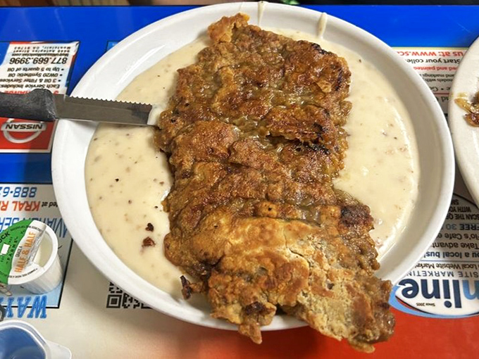 Country fried steak swimming in gravy&mdash;a dish so gloriously excessive it makes moderation seem like a terrible life choice.