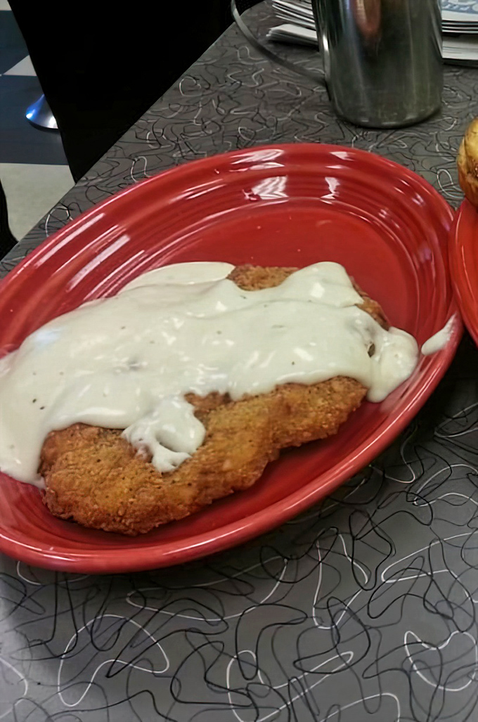 Country fried steak swimming in creamy gravy&mdash;the kind of dish that makes you want to hug the cook and take a nap immediately after.