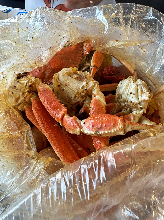 Snow crab legs lounging in their plastic bag spa, marinating in spices that will make your taste buds do the happy dance.