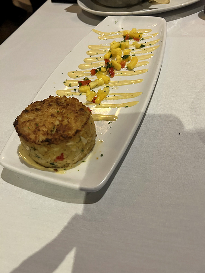 Pan-seared crab cake artistry that transforms humble crustaceans into pure golden magic on your plate.