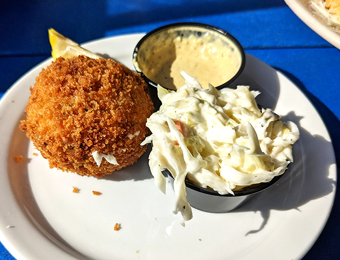 The golden-brown crab cake looks like it's auditioning for a seafood calendar &ndash; crispy exterior giving way to sweet crabmeat with minimal filler getting in the way.