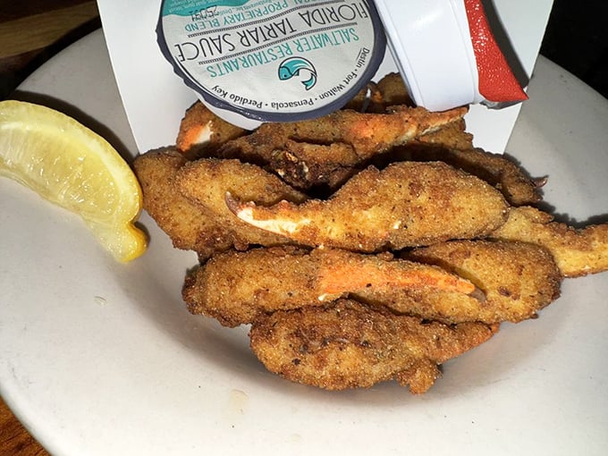 Golden-fried crab claws&mdash;the finger food that makes you forget your manners. That squeeze of lemon isn't optional; it's the final brushstroke on a masterpiece.