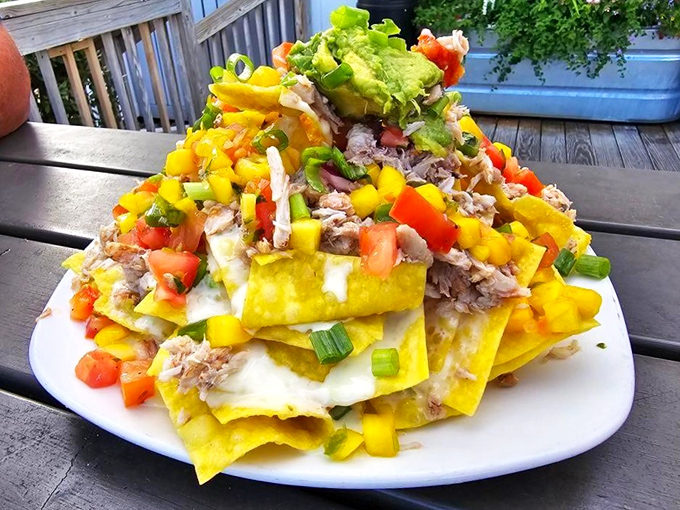 These crab nachos aren't just an appetizer, they're an architectural achievement&mdash;layers of tortilla chips, crab meat, and colorful toppings reaching skyward.