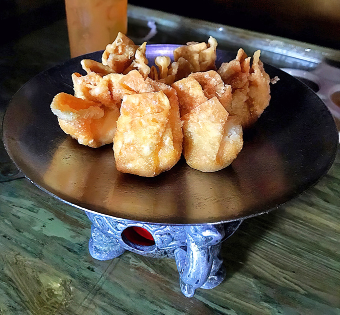 These golden crab rangoons aren't just appetizers&mdash;they're little crispy pillows of happiness, served on a stand that means business.