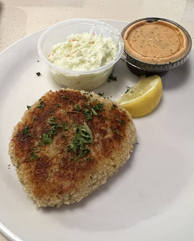 A golden-brown crab cake that doesn't hide behind fillers&mdash;just pure crab meat with a crispy exterior that shatters with each delicious bite.
