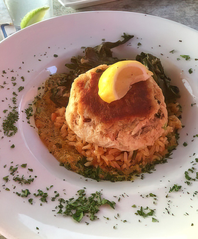 A crab cake that's actually cake-shaped crab, not the other way around. Served with rice and a lemon crown.