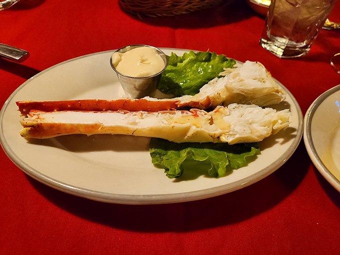Crab legs so impressive they deserve their own zip code, resting on crisp lettuce like seafood royalty waiting for their butter bath.