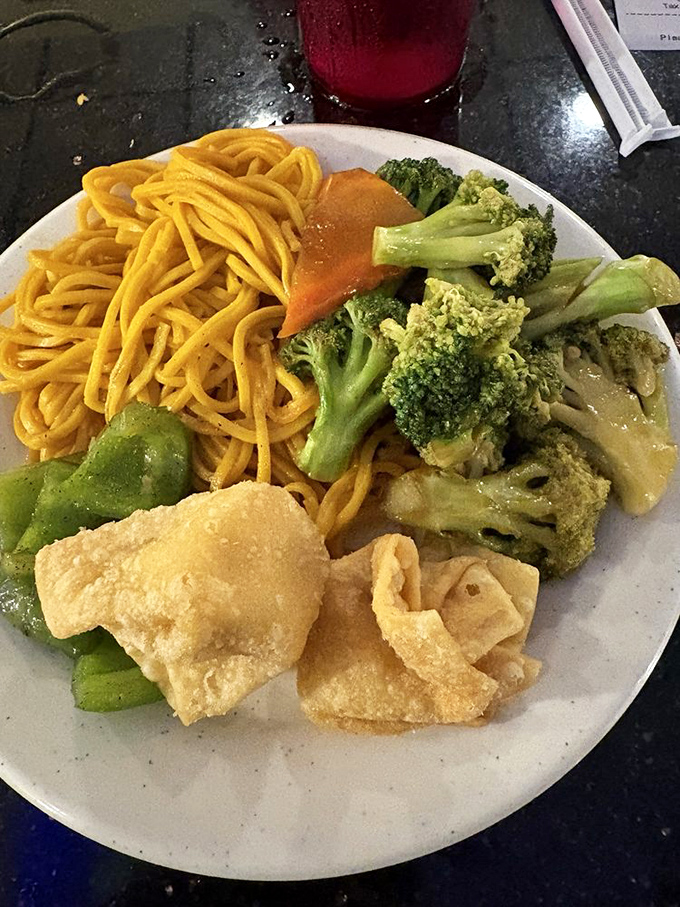 A plate that tells the story of Chinese-American cuisine &ndash; golden lo mein noodles playing supporting role to crispy wonton stars.