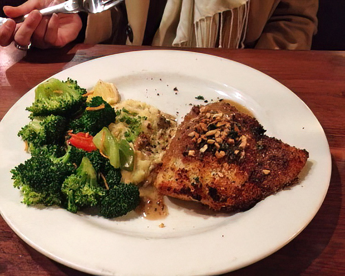 Surf meets turf in this ingenious creation: a tender fish filet crowned with macadamia nuts and accompanied by vibrant, perfectly cooked broccoli.