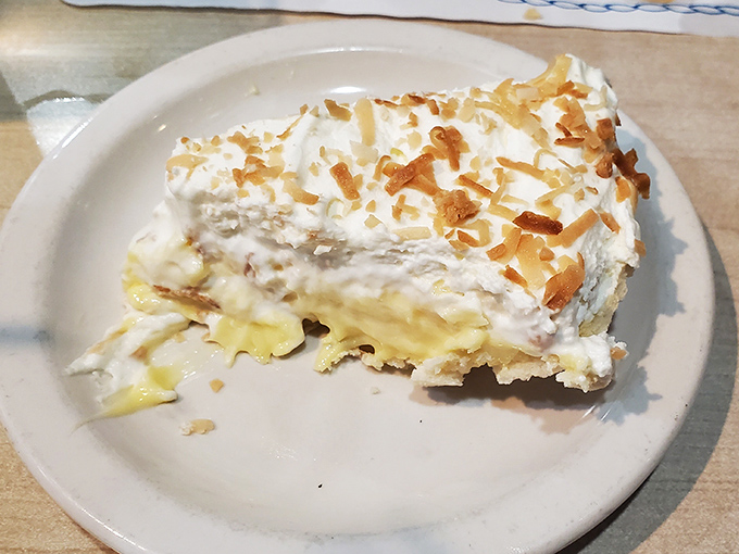 This coconut cream pie looks like a fluffy cloud decided to become dessert – and succeeded magnificently.