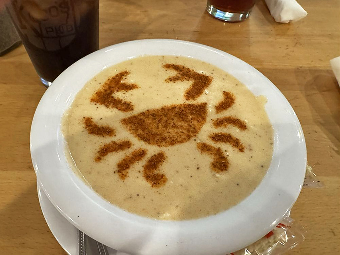 The cream of crab soup arrives with an artistic Old Bay crab silhouette&mdash;culinary skill meets Instagram-worthy presentation.