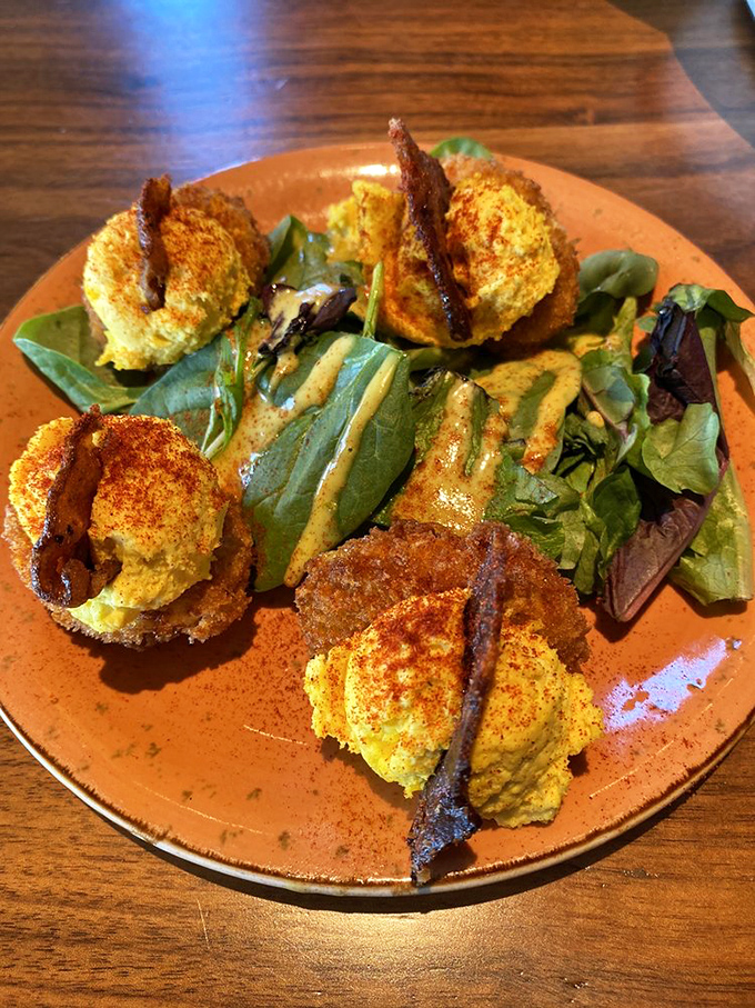 Deviled eggs got dressed up for dinner! These crispy-coated yellow jewels with bacon accents prove appetizers can steal the spotlight.