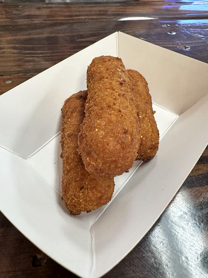 Golden croquetas standing at attention, ready to reveal their creamy interior secrets. Resistance is futile, order two portions.