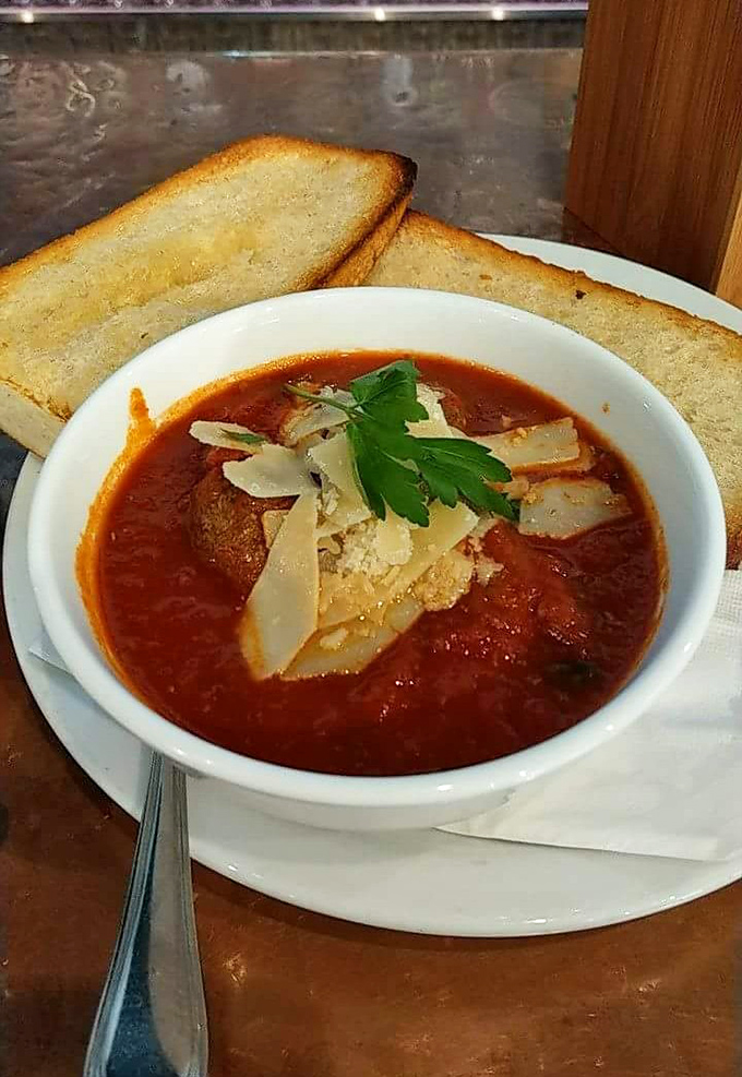 Tomato soup that puts Campbell's on notice, topped with cheese that doesn't come from a green shaker. Comfort food, elevated.