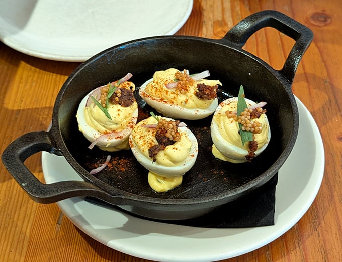 Deviled eggs get the star treatment here, served in cast iron with garnishes that make this humble picnic staple ready for its close-up.