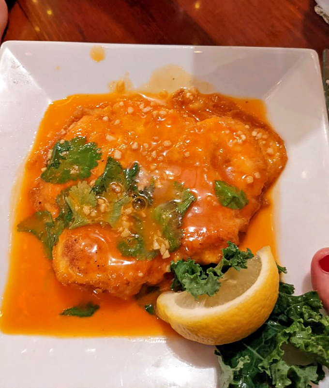 This vibrant orange sauce isn't just pretty—it's a flavor explosion that transforms ordinary fish into an extraordinary experience worth driving for.