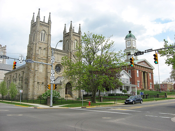 Gothic spires reach skyward alongside the courthouse clock tower, creating a postcard-perfect streetscape that Norman Rockwell would have rushed to paint.