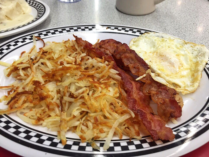 Breakfast perfection isn't complicated: crispy-edged hash browns, bacon with the ideal bend, and eggs that sunshine your plate into happiness.