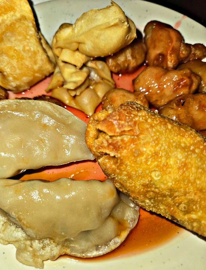 The humble egg roll—crispy armor protecting a treasure of savory filling—sits proudly among its buffet companions, waiting for its moment of glory.