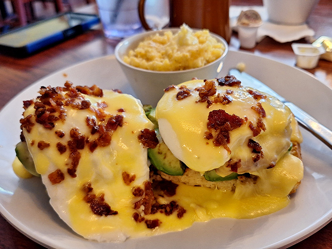 Eggs Benedict reimagined with avocado and bacon&mdash;a breakfast masterpiece that makes you wonder why you'd ever settle for a basic bowl of cereal again.