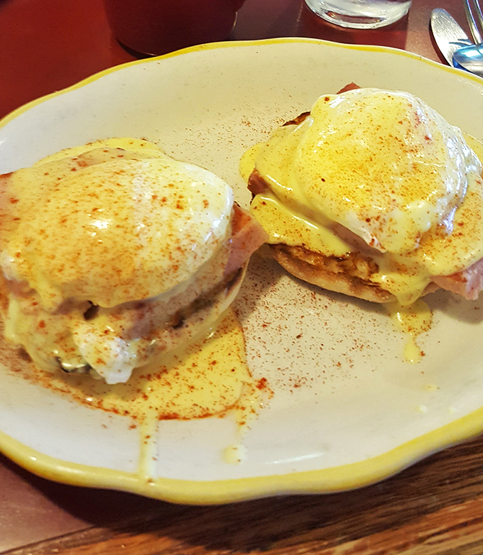 Eggs Benedict that would make a brunch snob weep with joy—perfectly poached eggs, Canadian bacon, and hollandaise sauce that's clearly not from a packet.
