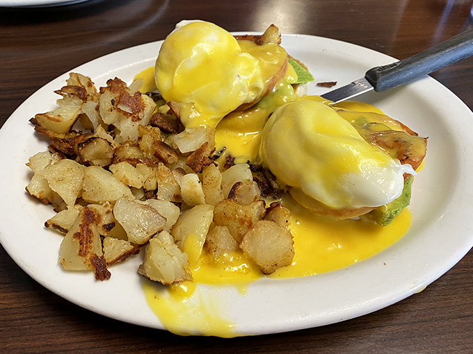 Eggs Benedict done right &ndash; that hollandaise cascades down like a yellow waterfall of happiness, making every bite a treasure hunt.