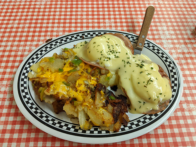 Eggs Benedict done right &ndash; creamy hollandaise cascading over poached perfection like edible sunshine on a plate.