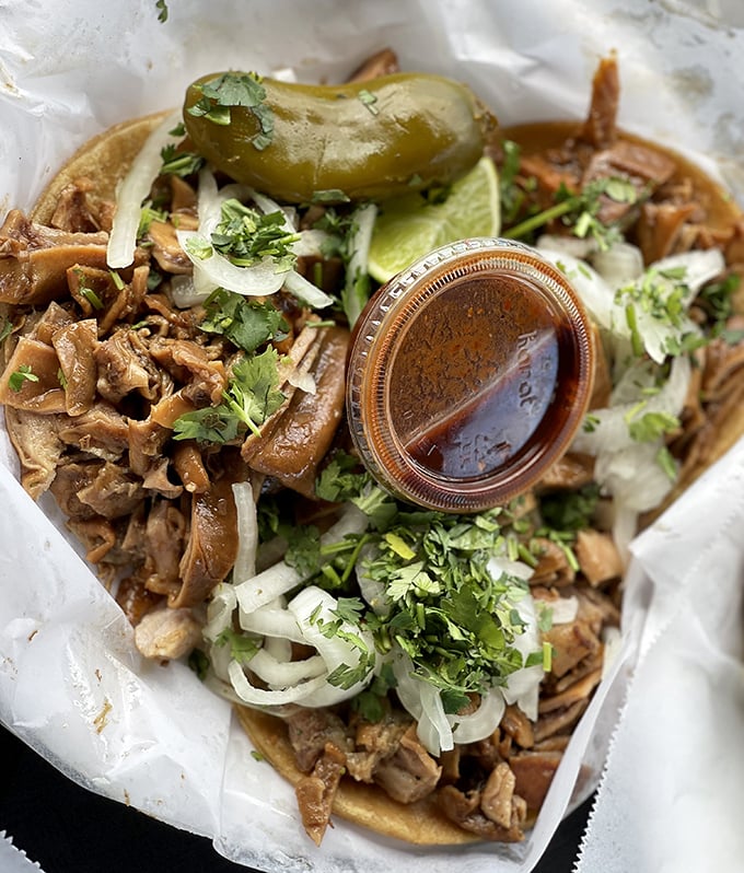 Simplicity perfected carnitas tacos adorned with just cilantro, onion, and a splash of salsa. Sometimes the universe needs only three ingredients to make magic.