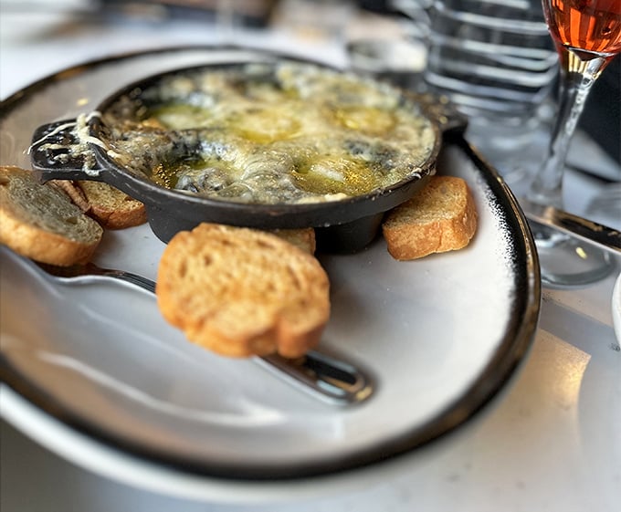 Escargot bubbling in garlicky butter with toast points standing by&mdash;because sometimes the best appetizers require a bit of courage and a lot of napkins.