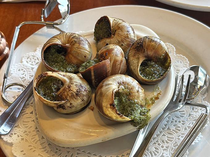 Escargots swimming in herb-flecked garlic butter that you'll be sopping up with bread long after the snails are gone. No judgment here.