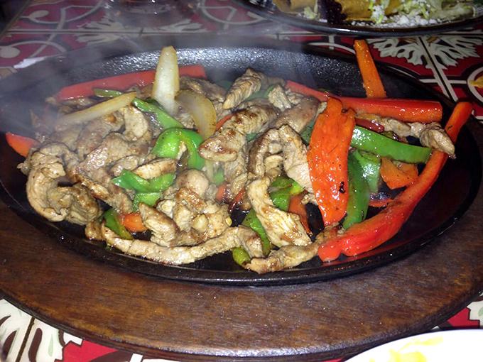 Sizzling fajitas that announce themselves to the entire restaurant. The steam rising off those peppers is basically Mexico's version of a dinner bell.