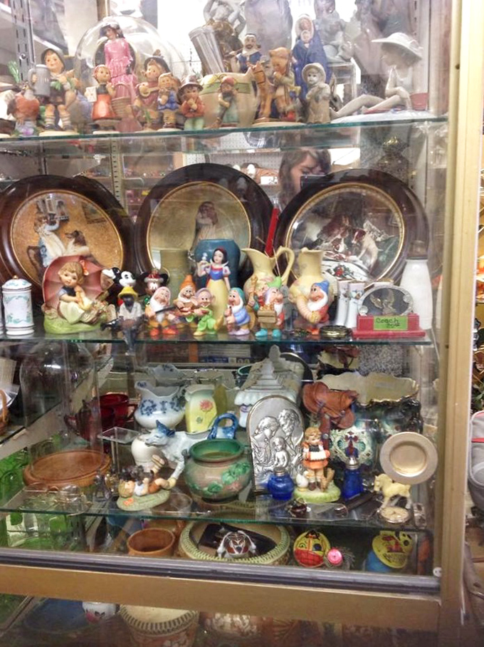 Snow White and the Seven Dwarfs stand guard over a menagerie of figurines&mdash;childhood memories preserved under glass, waiting for their next adventure.
