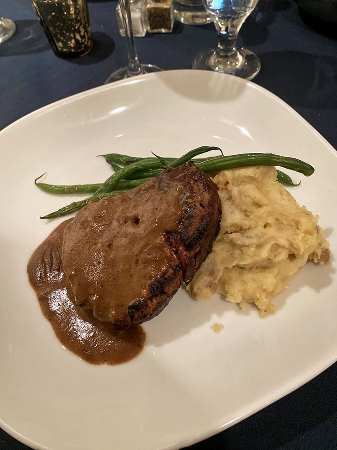 This isn't just a filet mignon; it's a masterclass in simplicity. The sauce pools like a gravy lake you'll want to swim in.