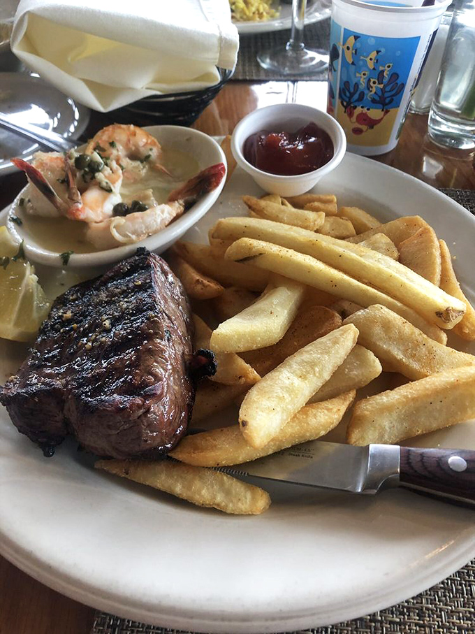 Surf meets turf in perfect harmony – a juicy steak alongside plump shrimp and fries that demand to be savored.