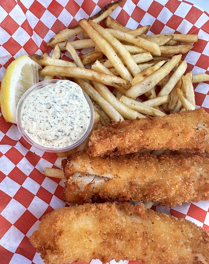 Golden-battered fish that shatters with each bite, paired with fries that deserve their own fan club. The tartar sauce is just showing off.