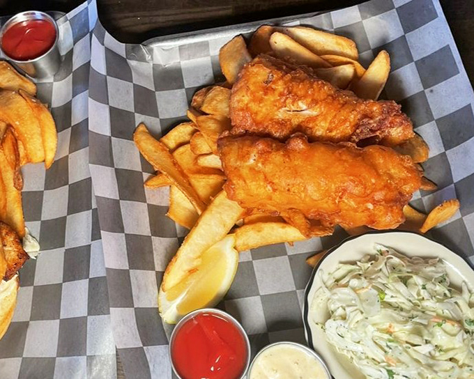 Golden-battered fish that shatters with each bite, nestled among hand-cut fries. The coleslaw adds just enough virtue to justify the indulgence.