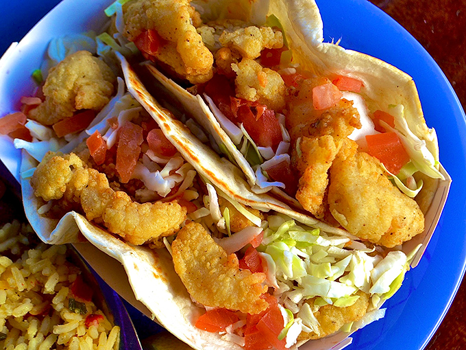 Seafood tacos done right &ndash; crispy shrimp nestled in soft tortillas with fresh slaw and diced tomatoes. Vacation on a plate!