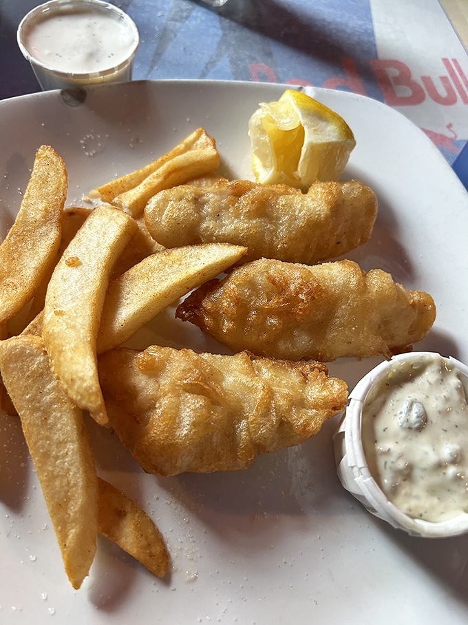 Golden-battered fish that shatters like glass alongside steak fries thick enough to use as bookmarks. Tartar sauce optional, but highly recommended.