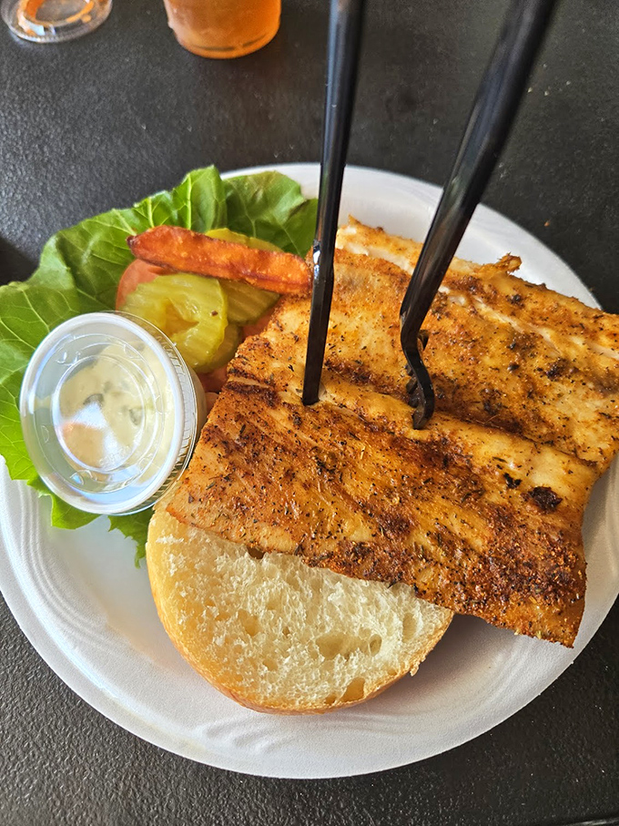 The blackened fish sandwich – where the fish extends beyond the bun's borders because generosity isn't just a virtue, it's a serving style.