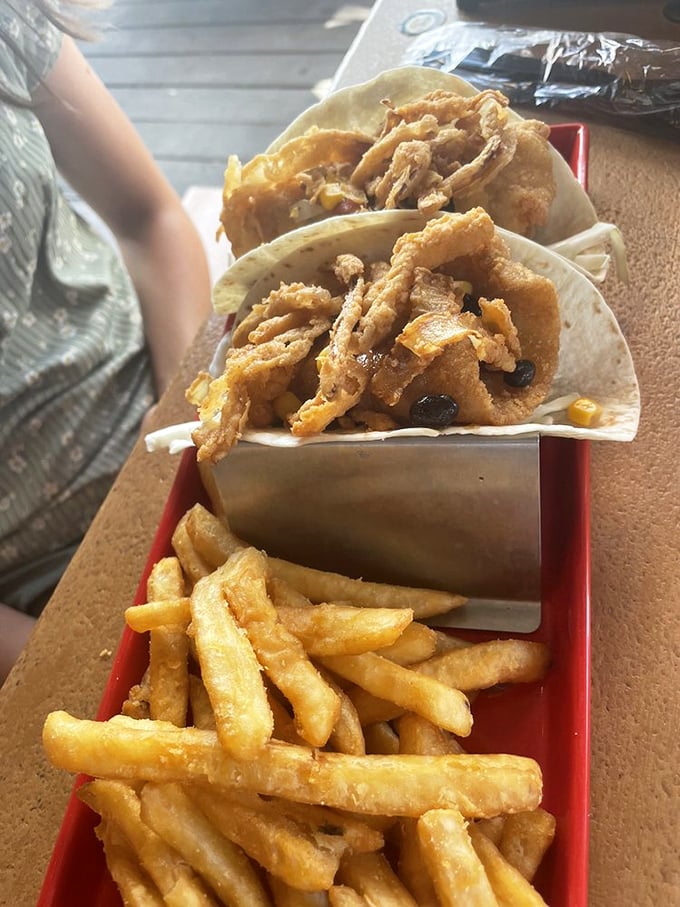 Tacos that deserve their own parade! Crispy fish nestled in soft tortillas with a side of fries that didn't come from a freezer bag.