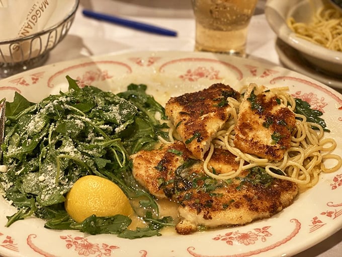 Perfectly seared chicken Francese lounging beside a bed of greens &ndash; like a culinary power couple that knows they look good together.