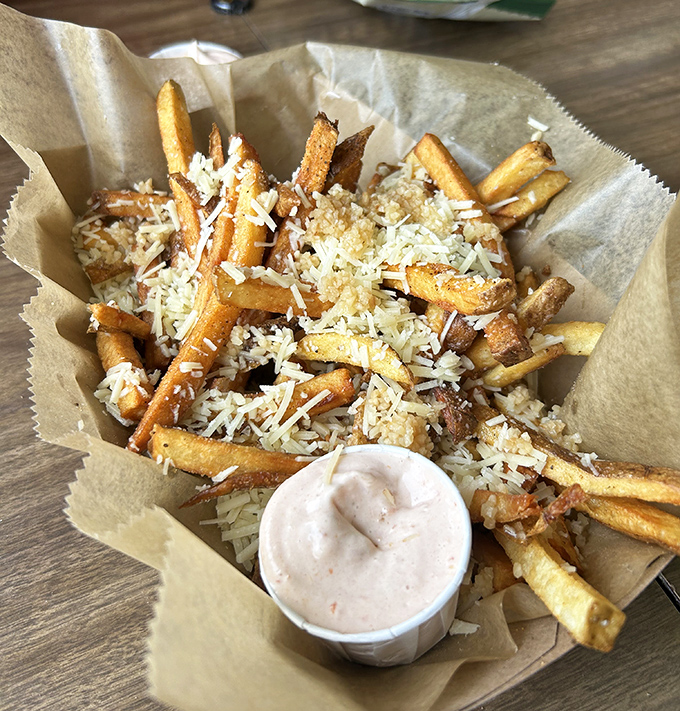 These aren't just fries&mdash;they're golden potato treasures dusted with parmesan fairy dust. That dipping sauce isn't an afterthought; it's the supporting actor deserving its own award.